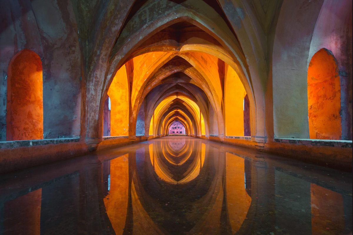 Gothic arches reflected in water creating an optical effect