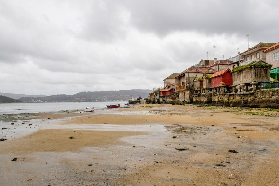 Historic seaside buildings in Combarro Galicia with waterfront walkway