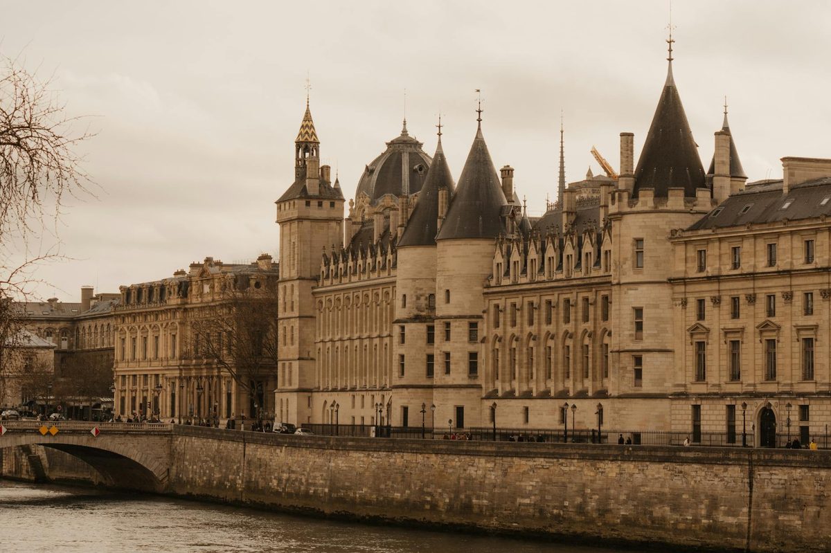Historic Conciergerie palace exterior along the Seine River in Paris
