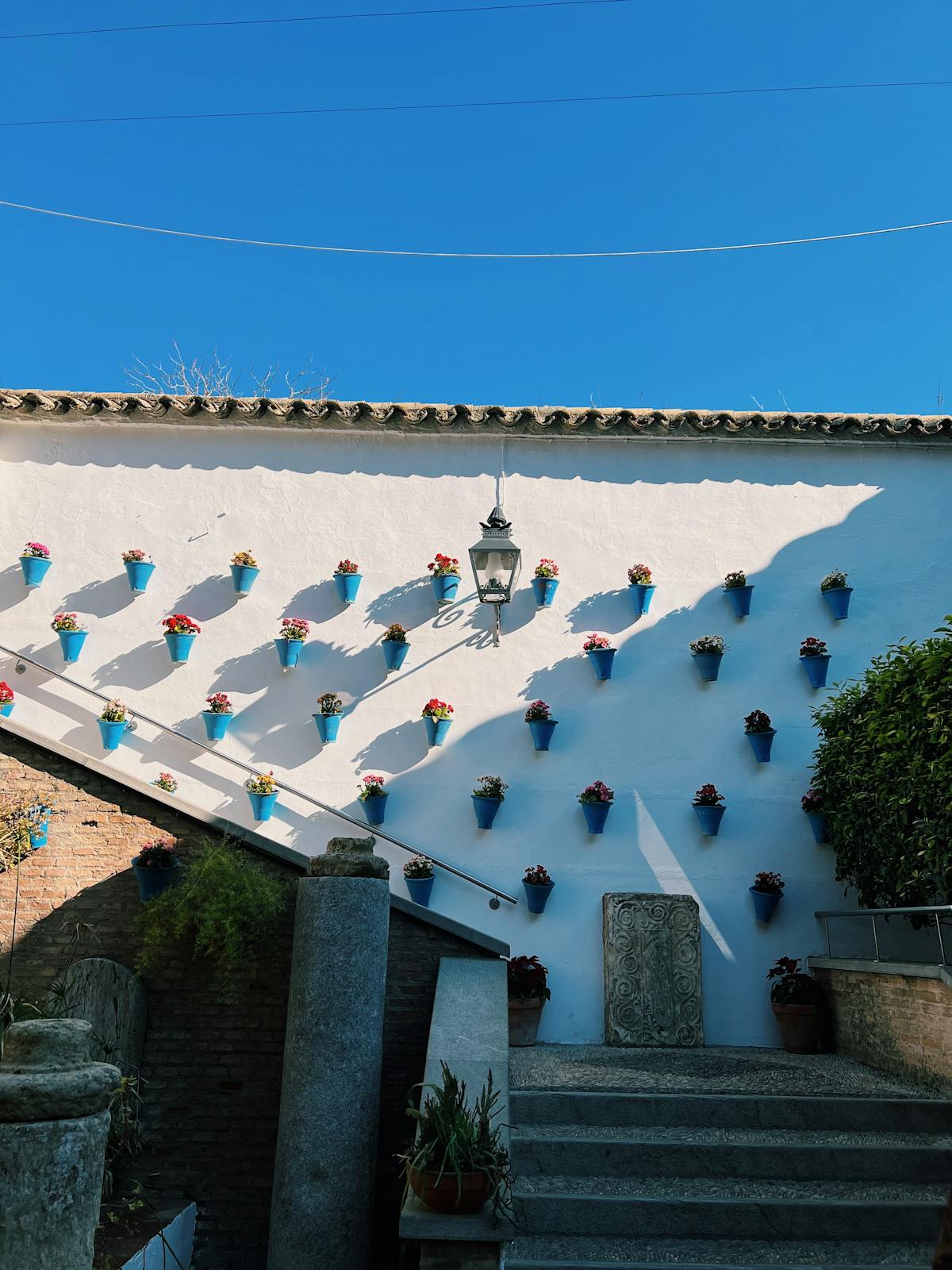Colorful flower pots on a whitewashed wall in Cordoba Spain