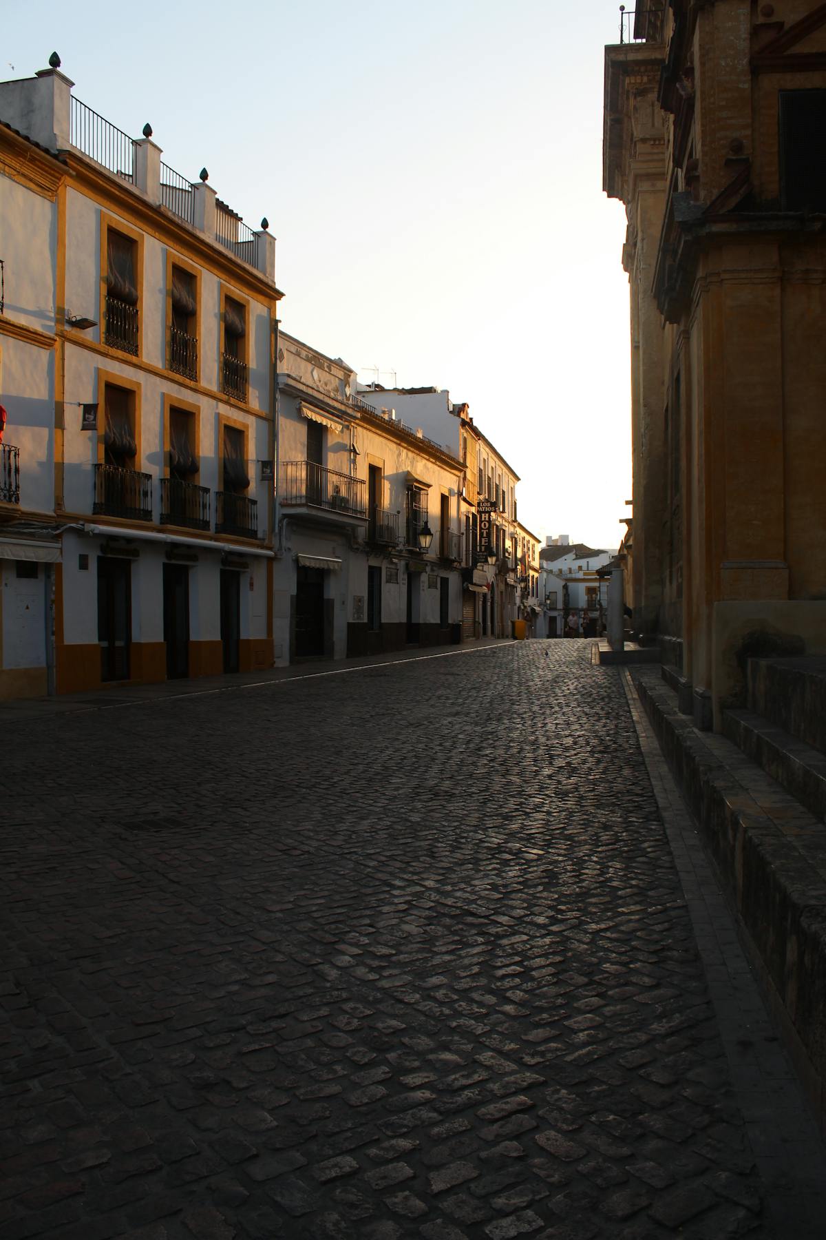 Narrow street in Cordoba Jewish Quarter at sunset