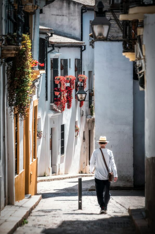 A traveler walking through the charming old streets of Cordoba