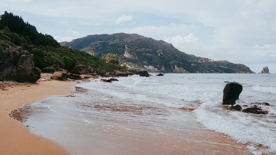 Serene coastal landscape in Corfu, Greece with waves and rocks