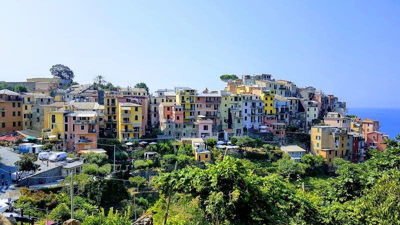 The hillside village of Corniglia perched high above the Ligurian Sea in Cinque Terre, surrounded by terraced vineyards