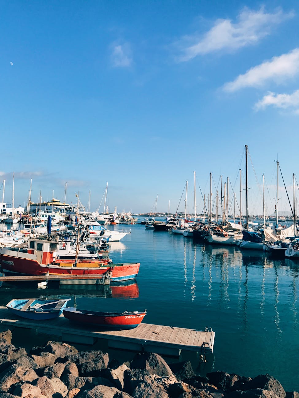 Colourful boats docked at Corralejo harbour in Fuerteventura