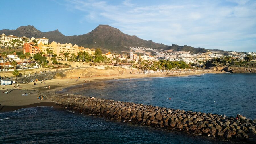 Scenic aerial view of Costa Adeje beach and town in Spain during sunset