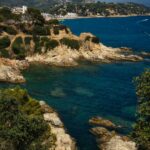 Aerial view of the rocky Costa Brava coastline with clear blue water