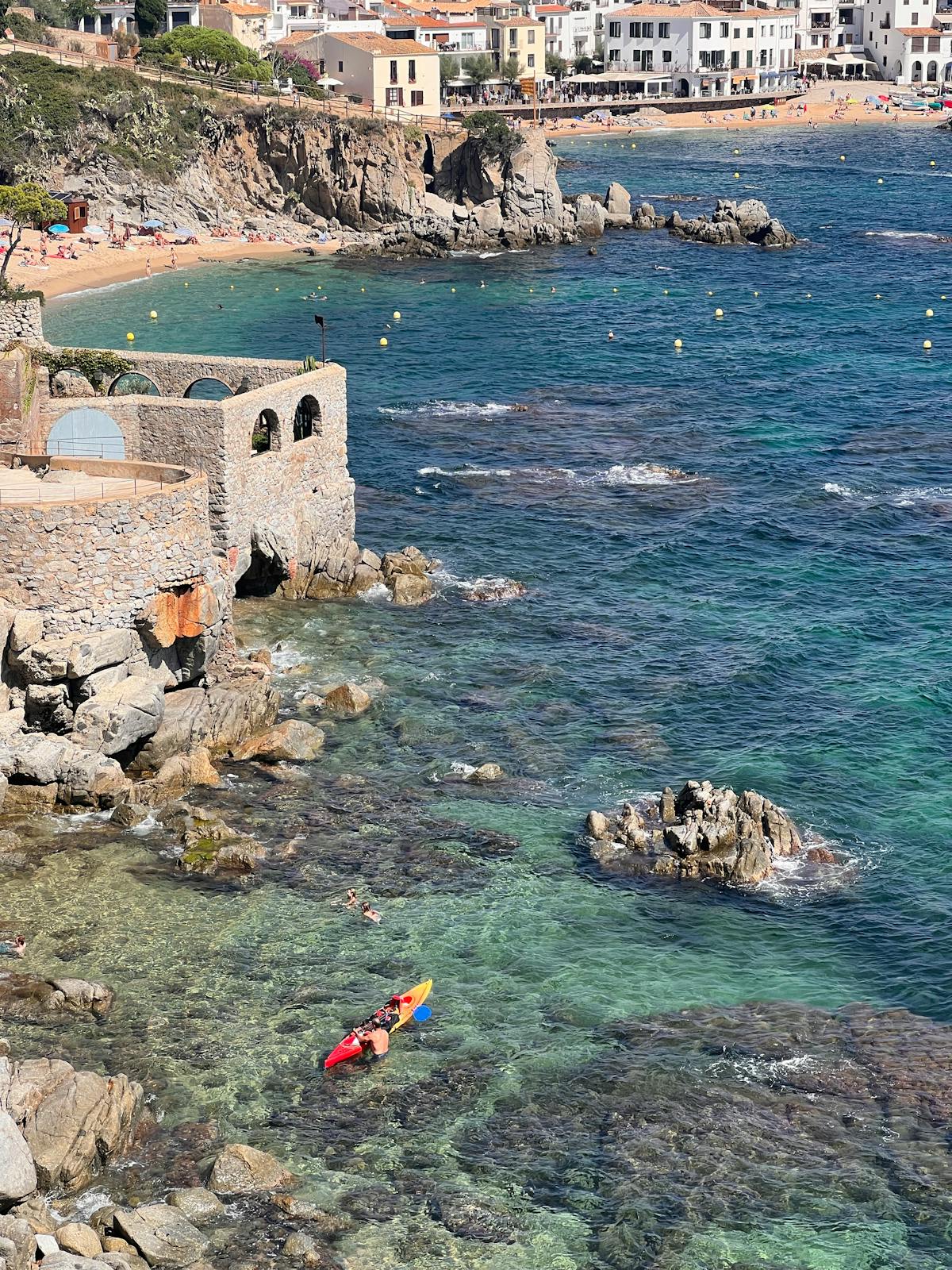 Kayakers paddling through stunning sea caves along the Costa Brava coastline