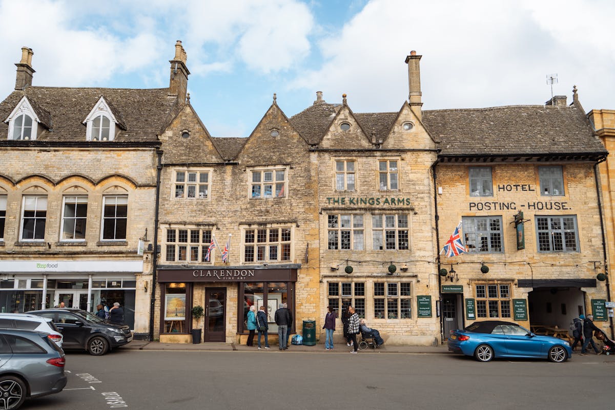 A Cotswolds cottage with a colorful front garden and stone walls