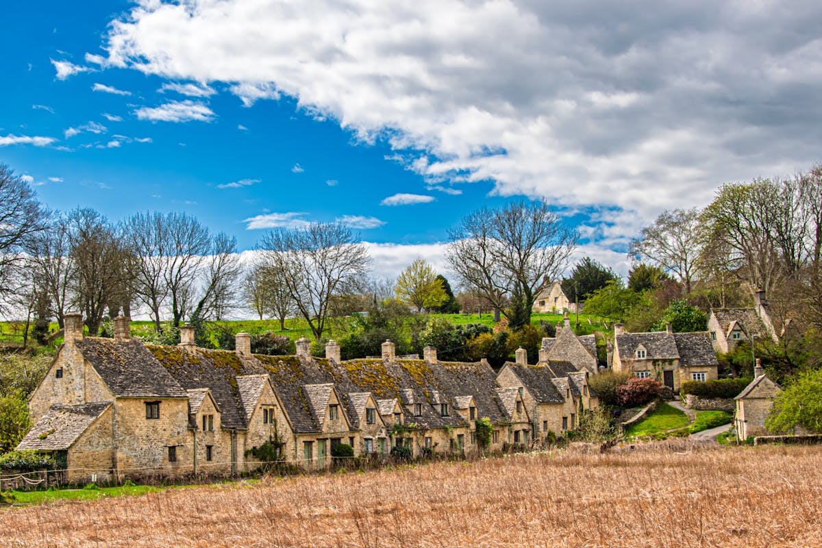Lush green rolling hills and farmland in the Cotswolds countryside