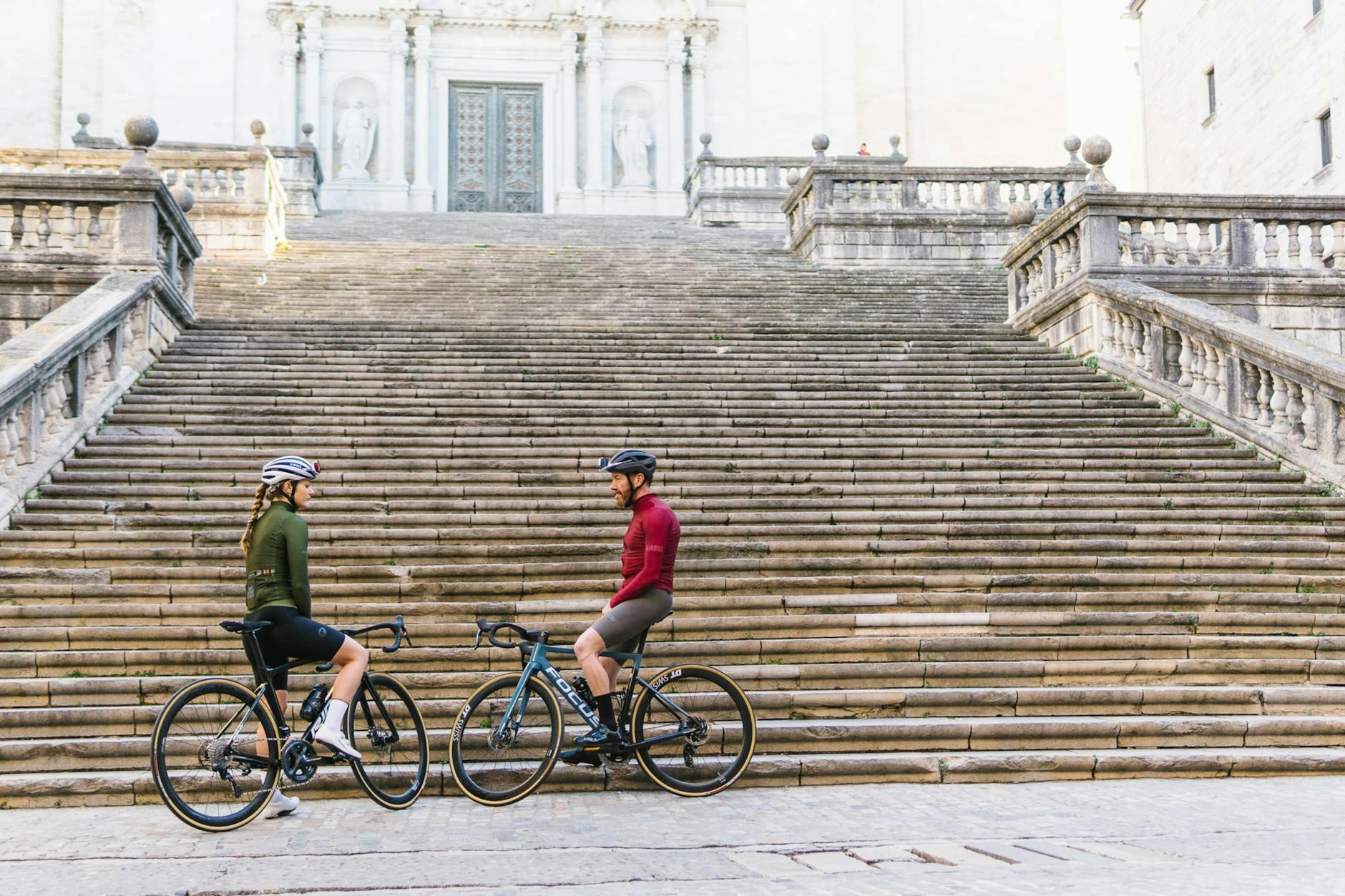 Couple cycling through a European city