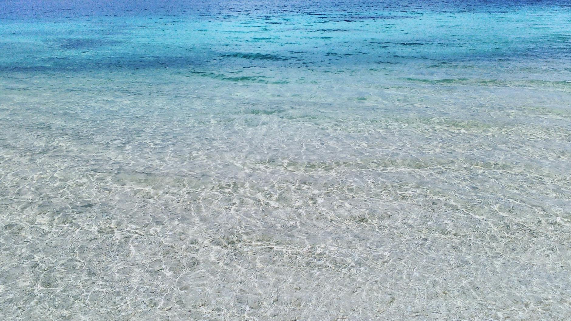 Clear turquoise waters on a sandy beach