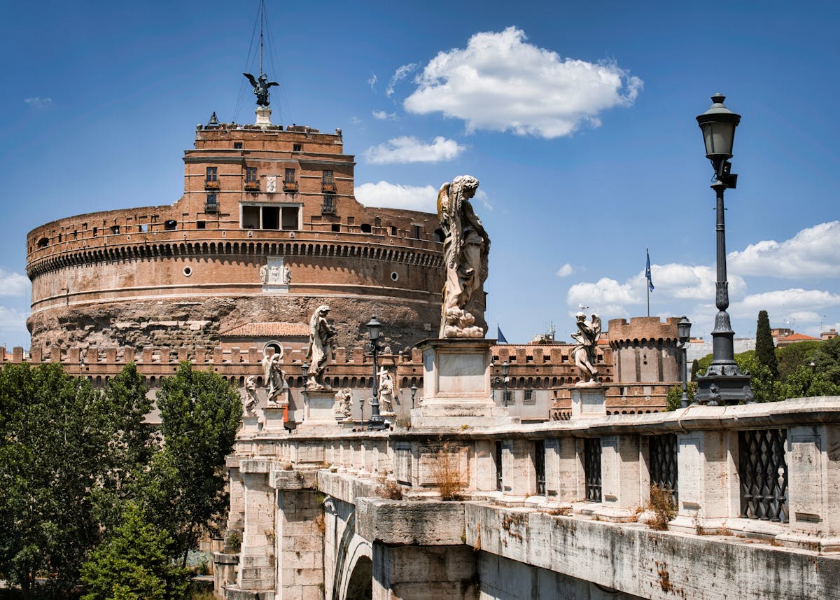 Historic view of Ponte Sant Angelo bridge with angel sculptures leading to Castel Sant Angelo