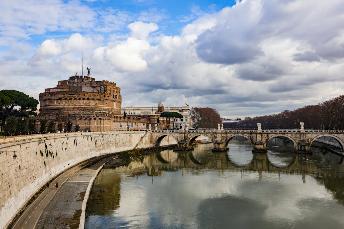 Castel Sant Angelo and Ponte Sant Angelo bridge reflected in the Tiber River at dawn