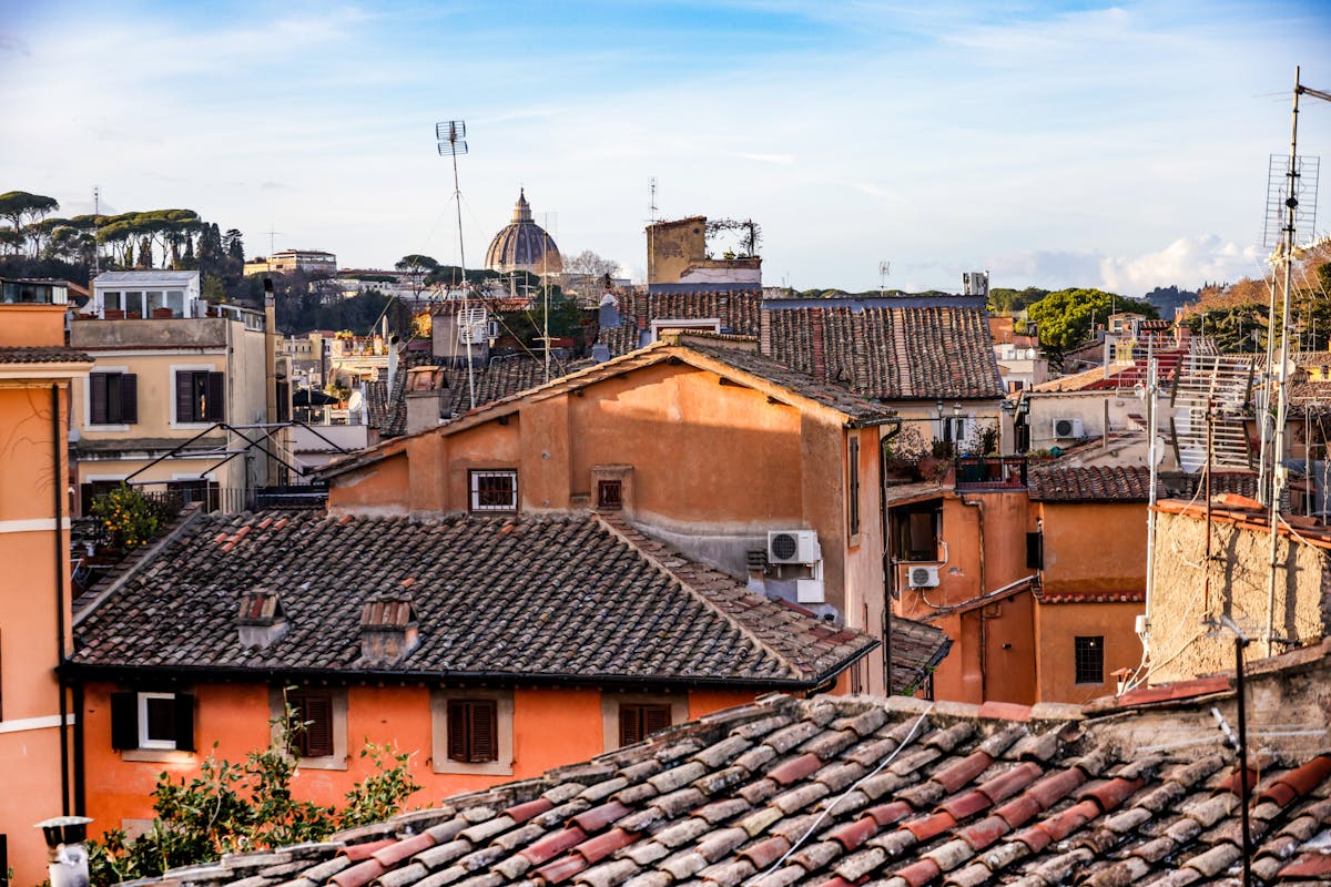 Panoramic view of Rome rooftops with the dome of St Peters Basilica visible in the distance