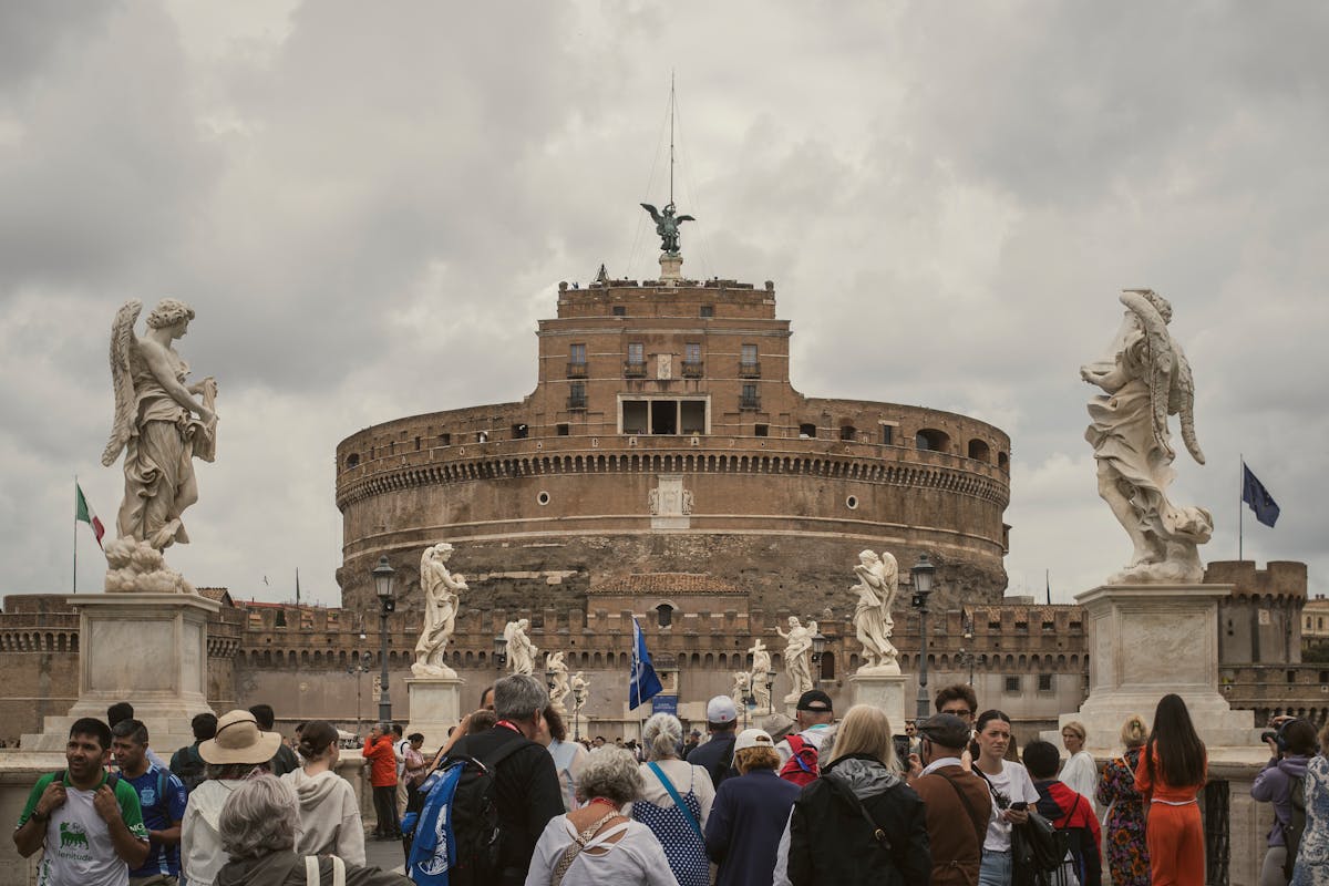 Tourists at Castel Sant Angelo with historic statues and architecture