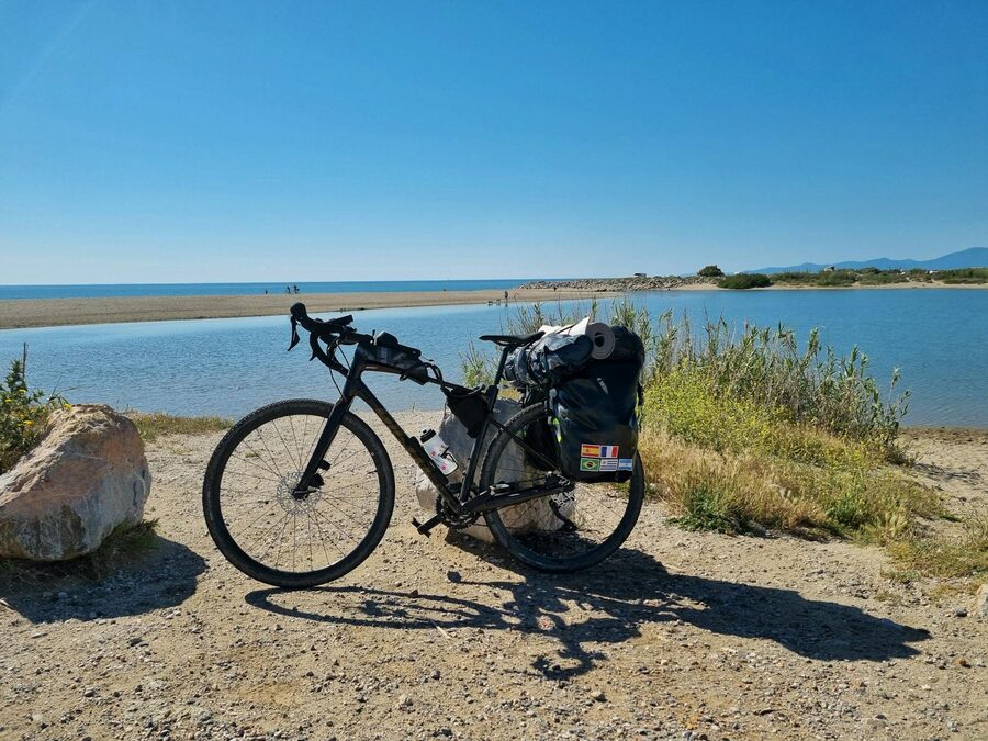 Bicycle with travel gear on a scenic coastal path along the Mediterranean