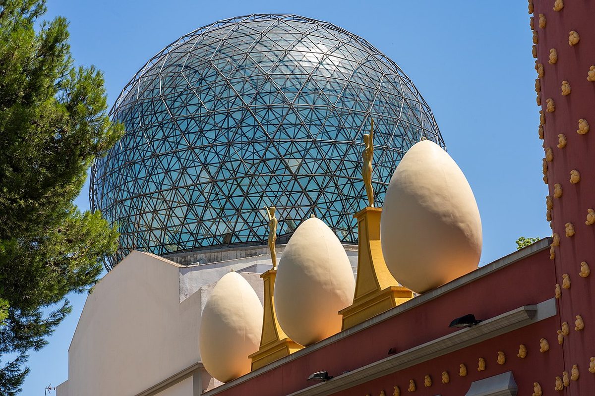 The Dali Theatre-Museum facade in Figueres with golden statues and egg sculptures on the rooftop