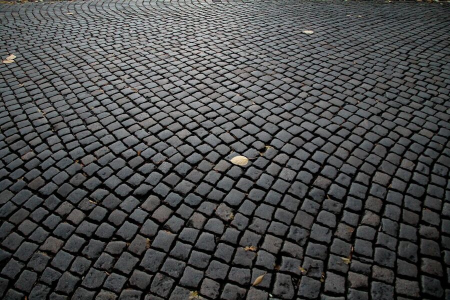 Charming cobblestone street in Prague Old Town with travelers and historic architecture