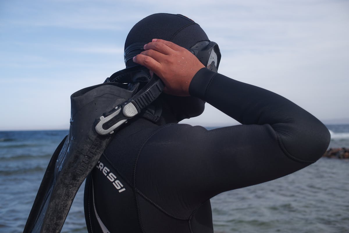 Diver adjusting snorkel mask preparing for ocean dive