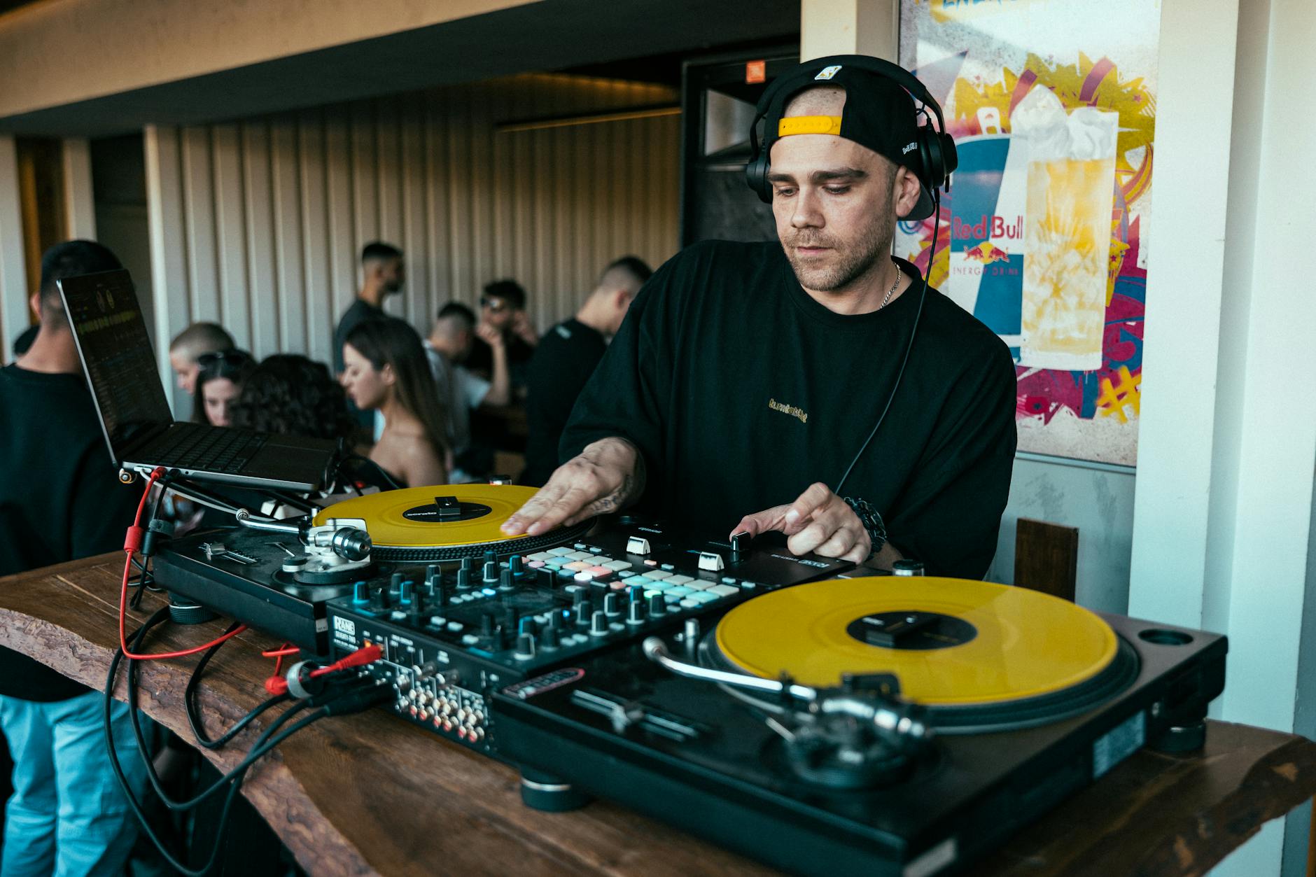 DJ mixing music with turntables and vinyl records at a party