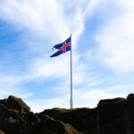 Sleeping Beauty Castle at Disneyland Paris with visitors walking along Main Street