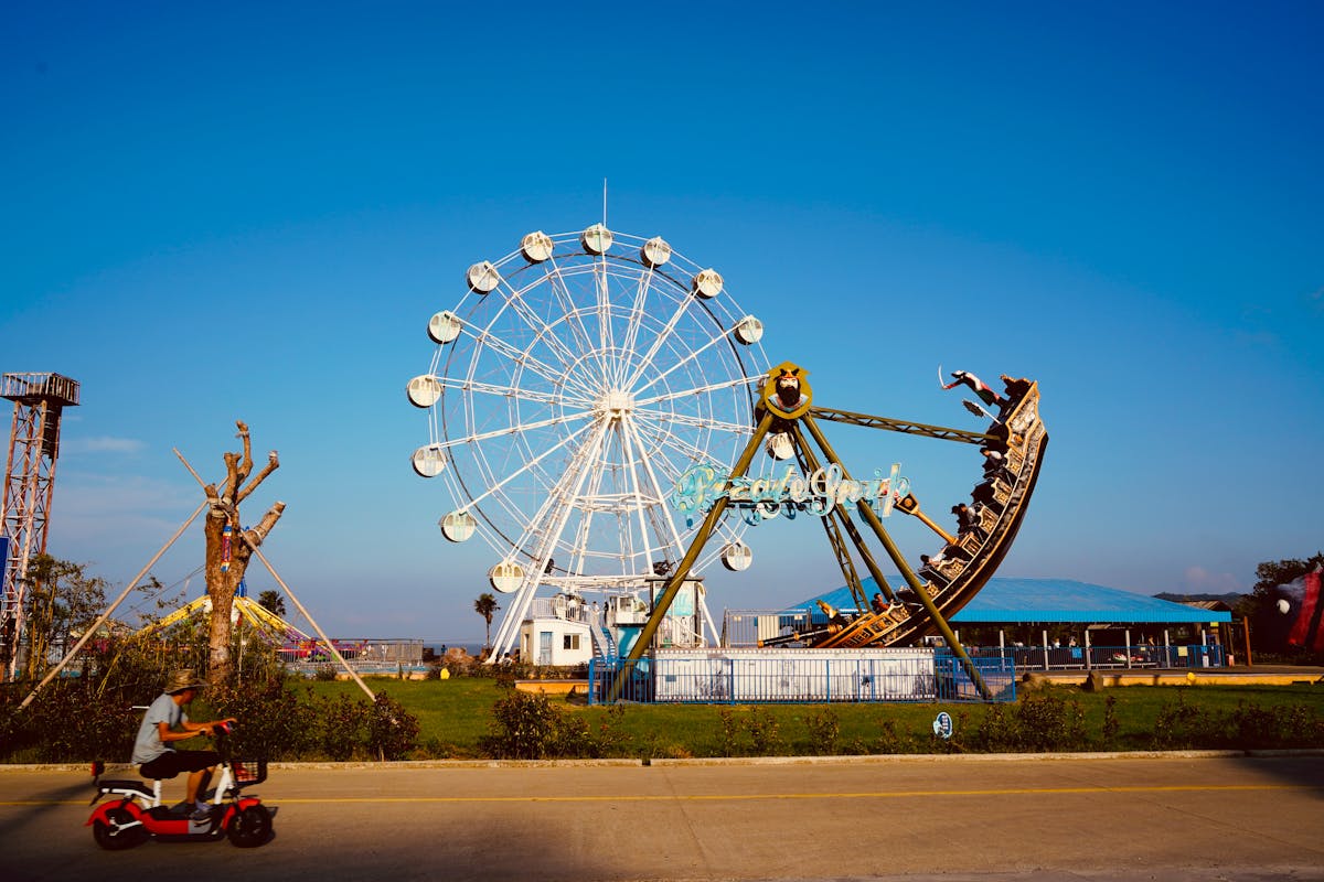 Theme park ride with colorful cars against a blue sky