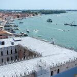 Aerial view of Doges Palace, St Marks Campanile, and Venice waterfront from above