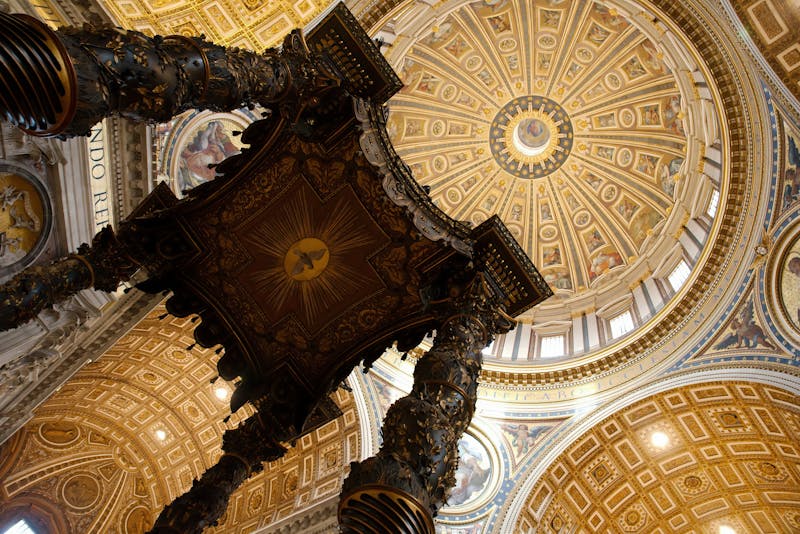Looking up inside St Peter's dome showing the elaborate mosaics and golden decorations