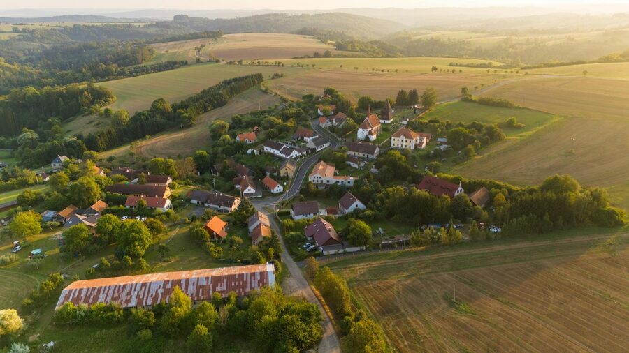 Drone photograph of a Czech village surrounded by farmland and forests