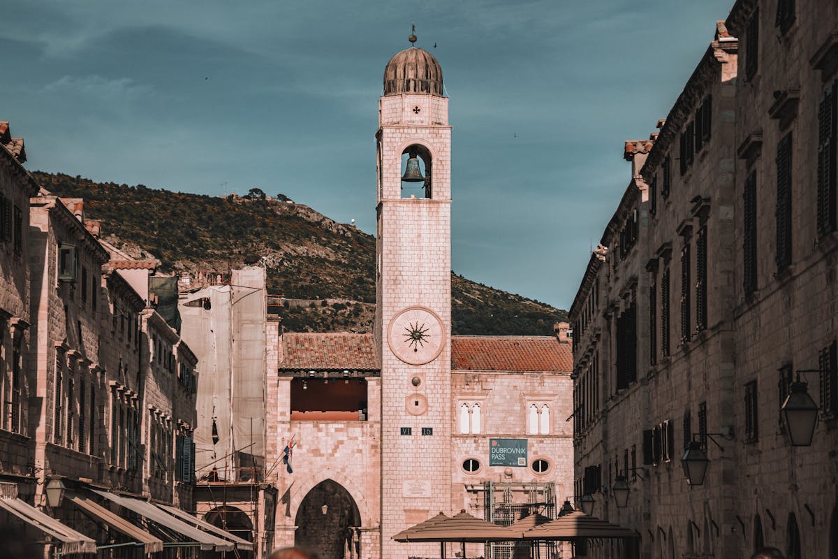 Historic clock tower in sunlit streets of Dubrovnik Old Town