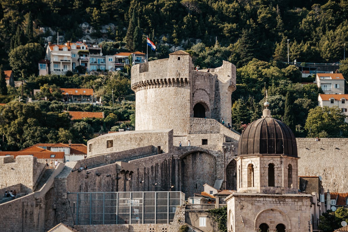 Historic Dubrovnik fortress wall with lush greenery and architecture