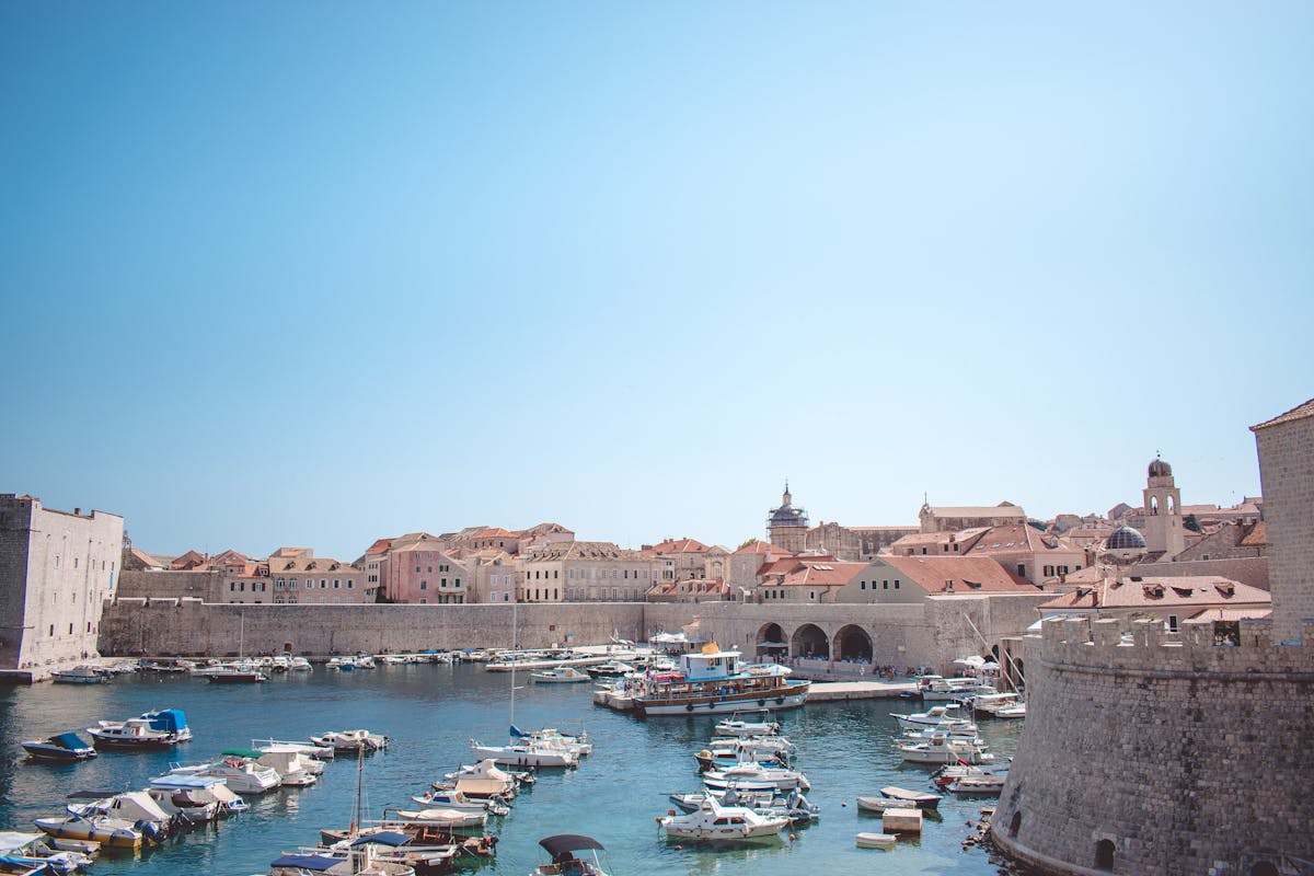 Historic harbor in Dubrovnik Old Port with boats and medieval stone buildings