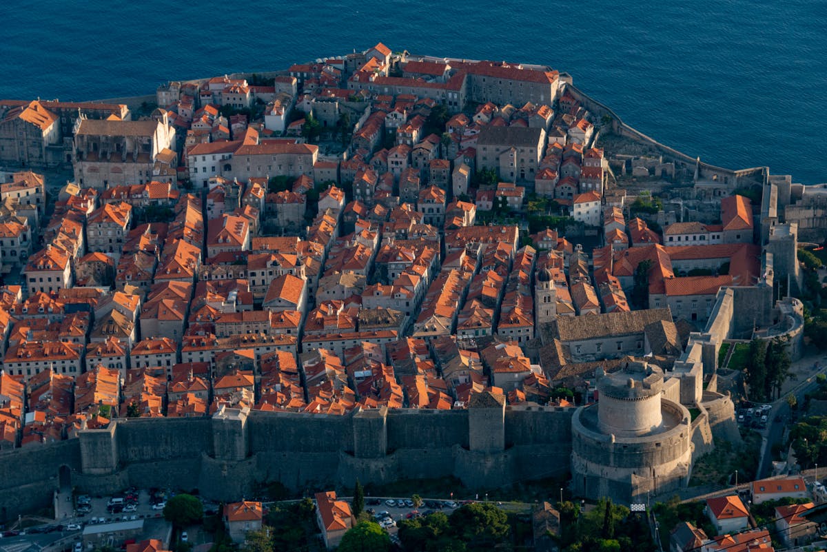 Aerial view of Dubrovnik Old Town with medieval castle walls and terracotta rooftops along the Adriatic coast