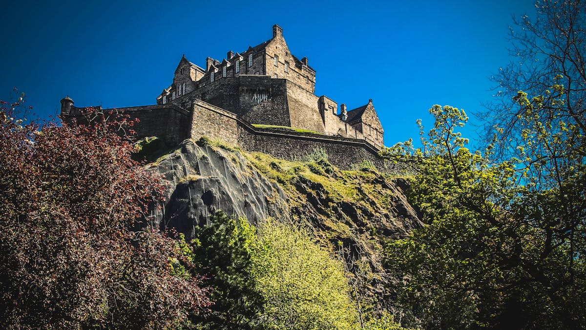 Edinburgh Castle perched atop Castle Rock under a clear sky