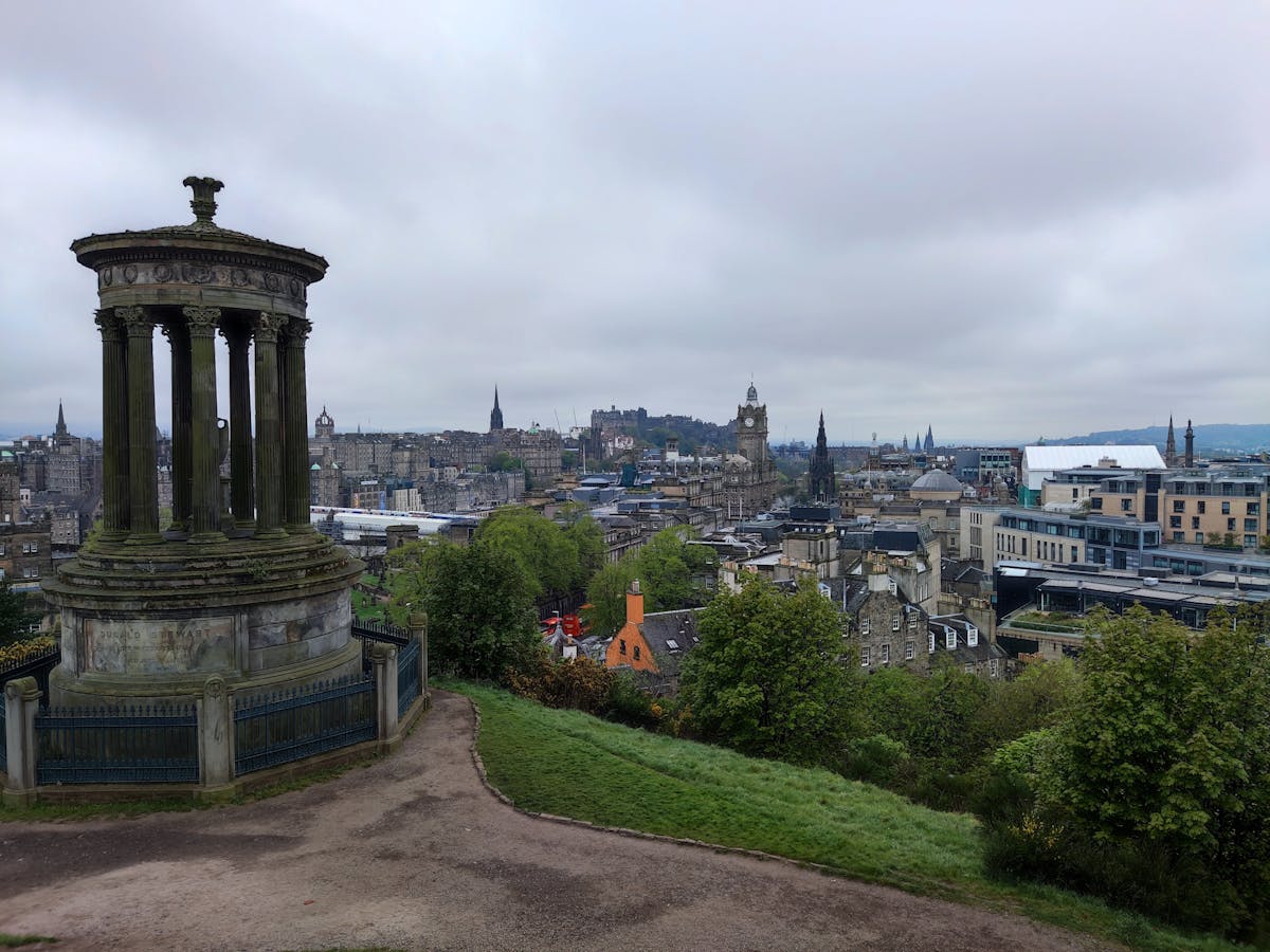Panoramic view of Edinburgh skyline with the Dugald Stewart Monument on Calton Hill in the foreground and the city stretching to the horizon