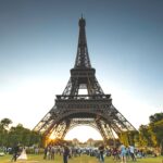 Tourists enjoying the Eiffel Tower on a sunny day in Paris