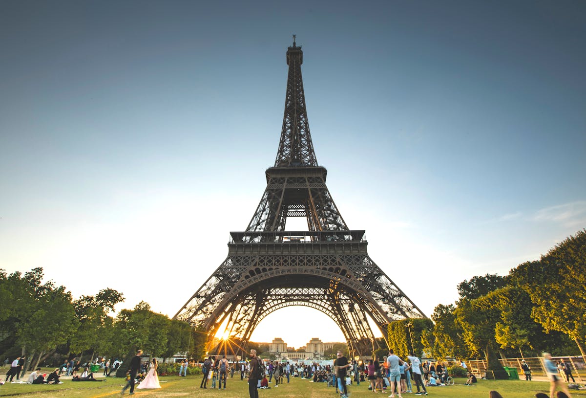 Tourists enjoying the Eiffel Tower on a sunny day in Paris