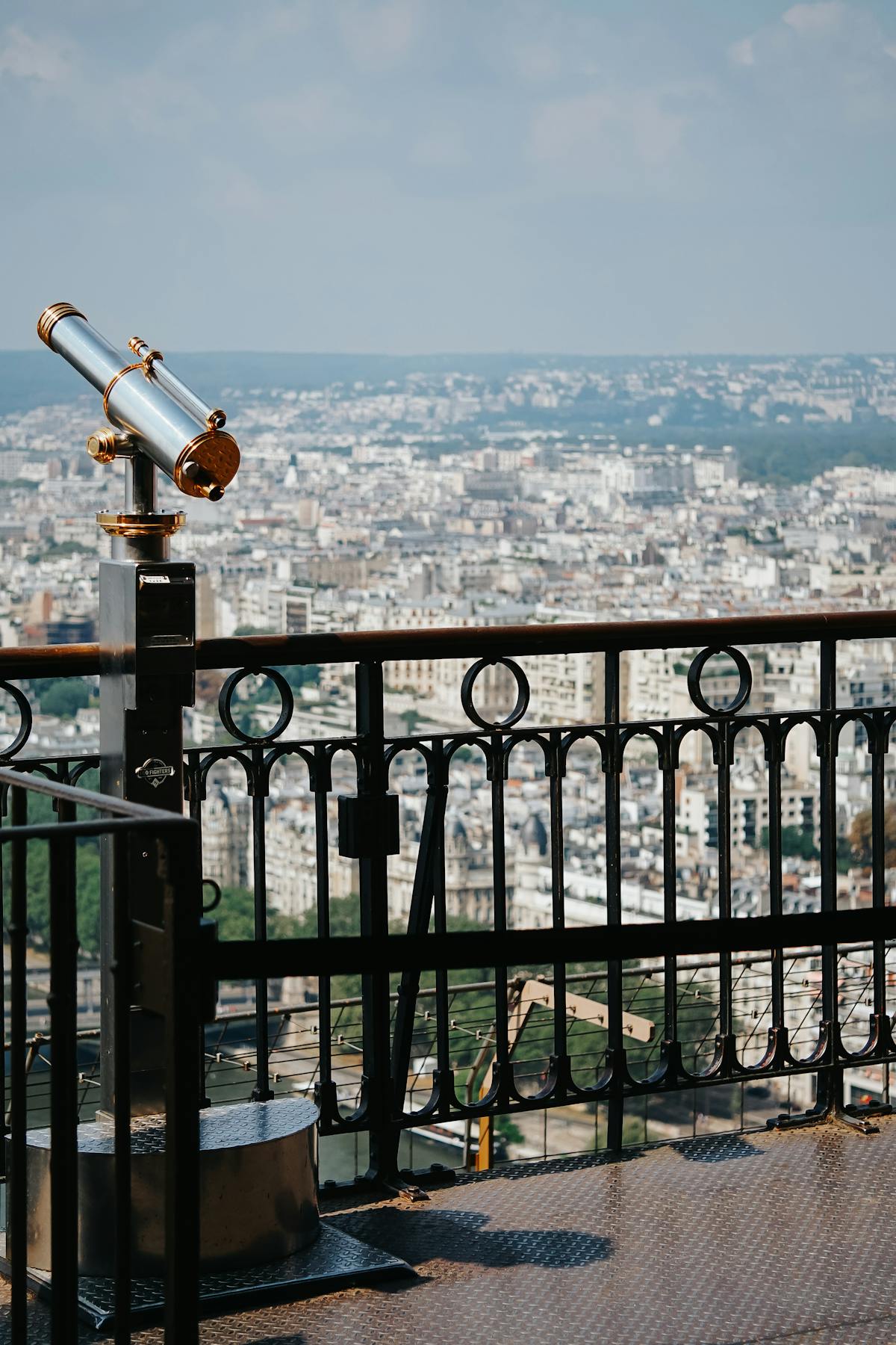 Telescope on observation deck with Paris city view below
