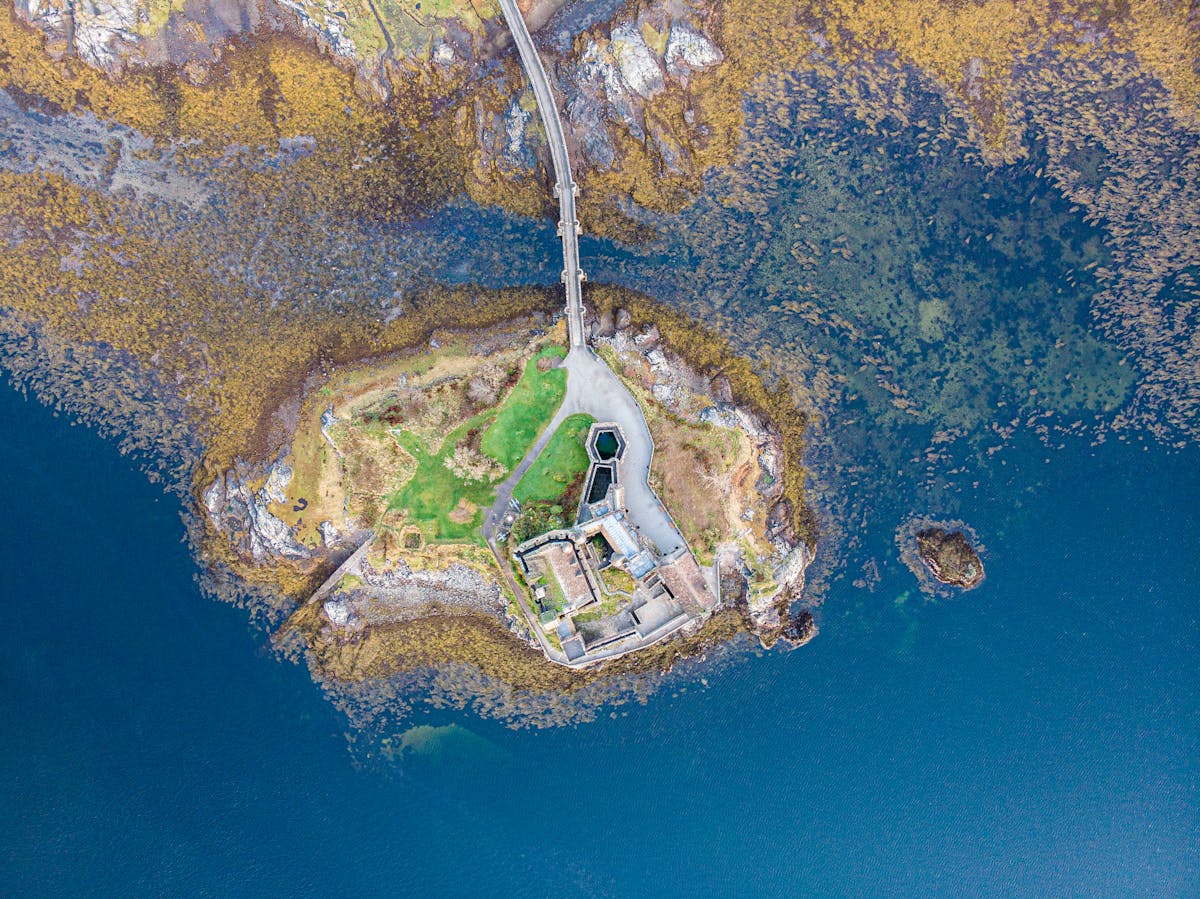 Aerial view of Eilean Donan Castle on a small island where three lochs meet
