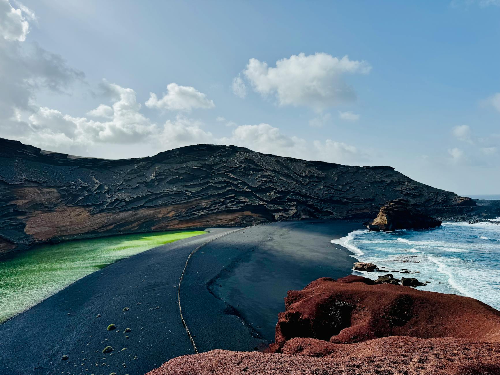 Dramatic volcanic landscape of El Golfo Lanzarote with green lagoon