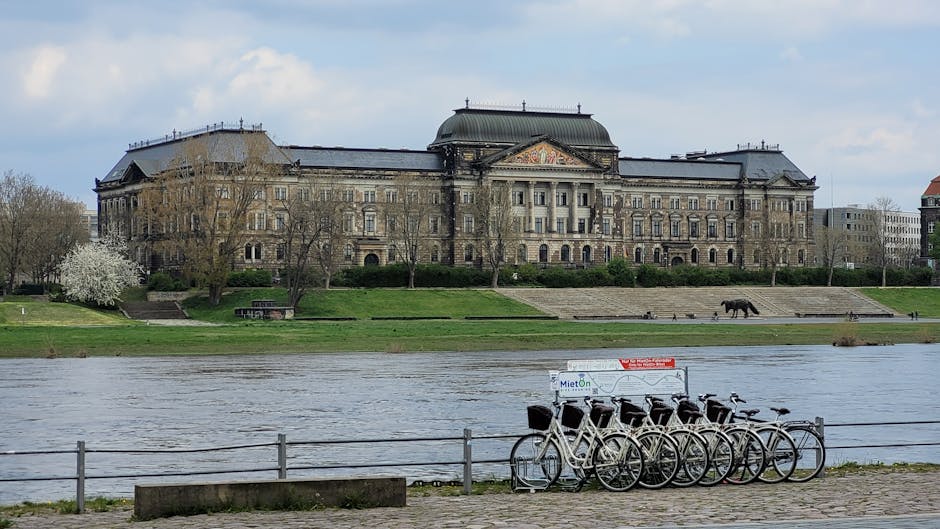 Bicycles parked along the Elbe River with historic Dresden buildings