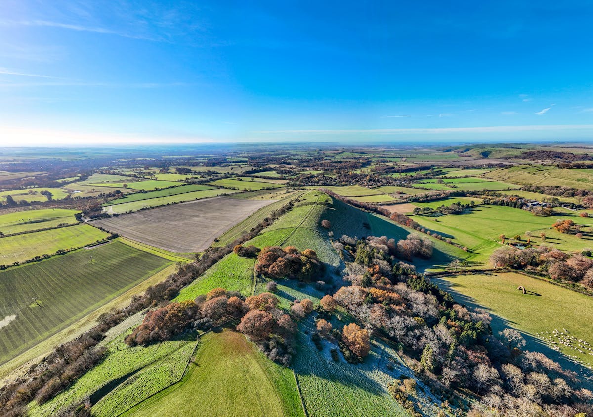Aerial view of rolling green English countryside with fields and hedgerows