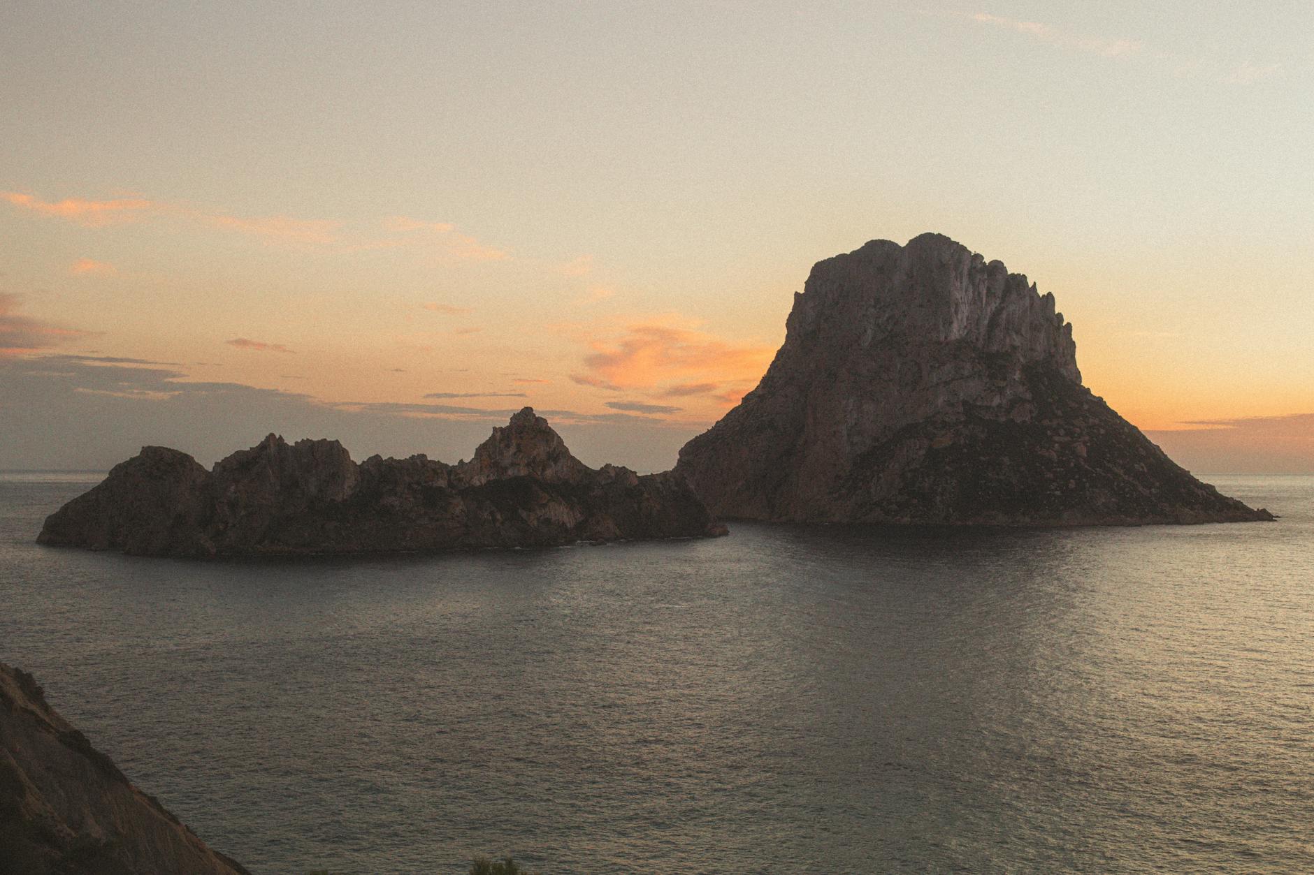 Es Vedra island silhouette during sunset off the coast of Ibiza