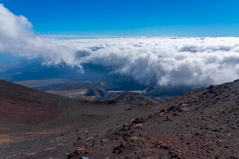 Mount Etna rising dramatically above a blanket of clouds in Sicily