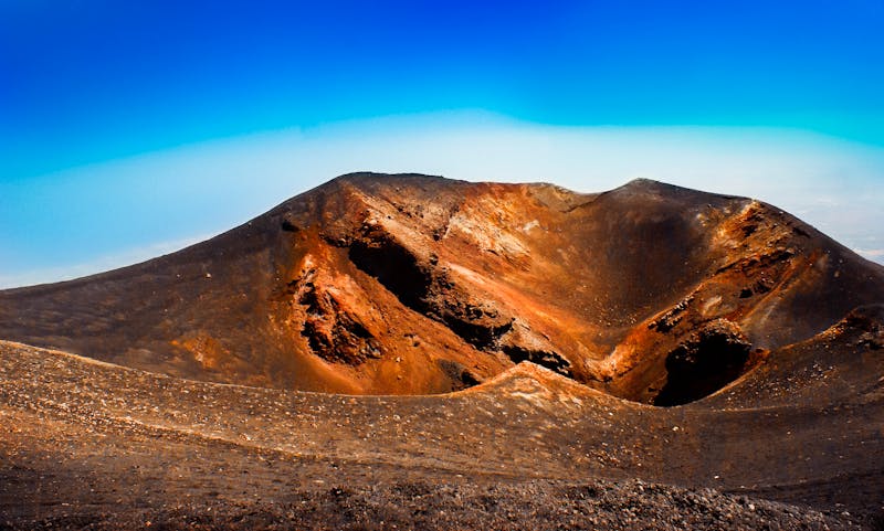 Colorful volcanic crater landscape on Mount Etna under blue sky in Sicily
