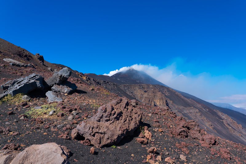 Rugged volcanic landscape of Mount Etna with clouds of mist in Sicily