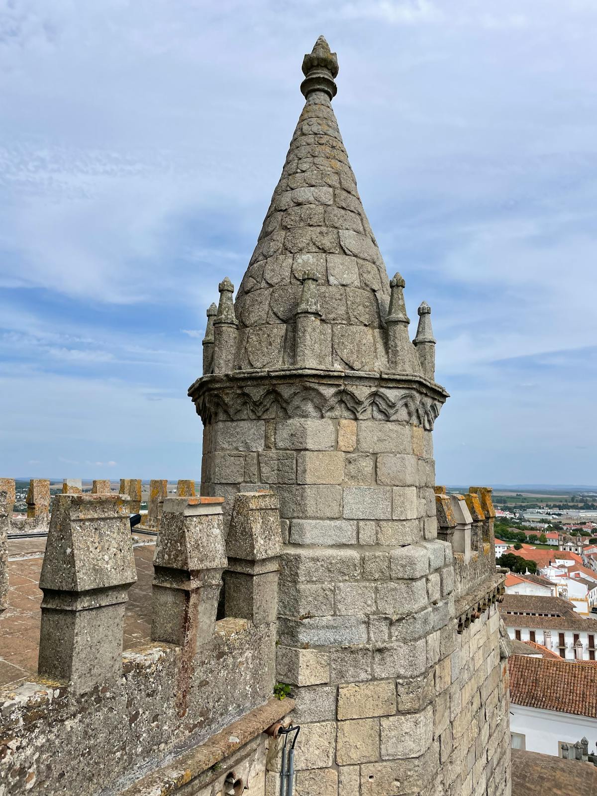 Gothic stone tower of Évora Cathedral against a clear sky