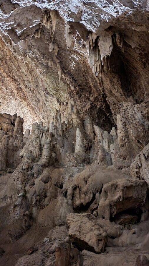 Impressive stalactite formations inside a cave in Spain with soft lighting
