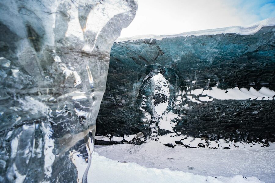 Explore the breathtaking beauty of a glacier ice cave in Iceland's winter landscape.